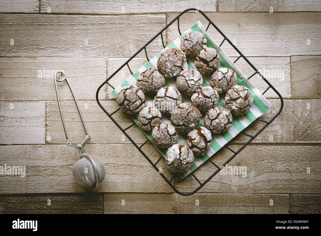 Chocolate crinkle cookies in a basket on wooden table. Top view ...