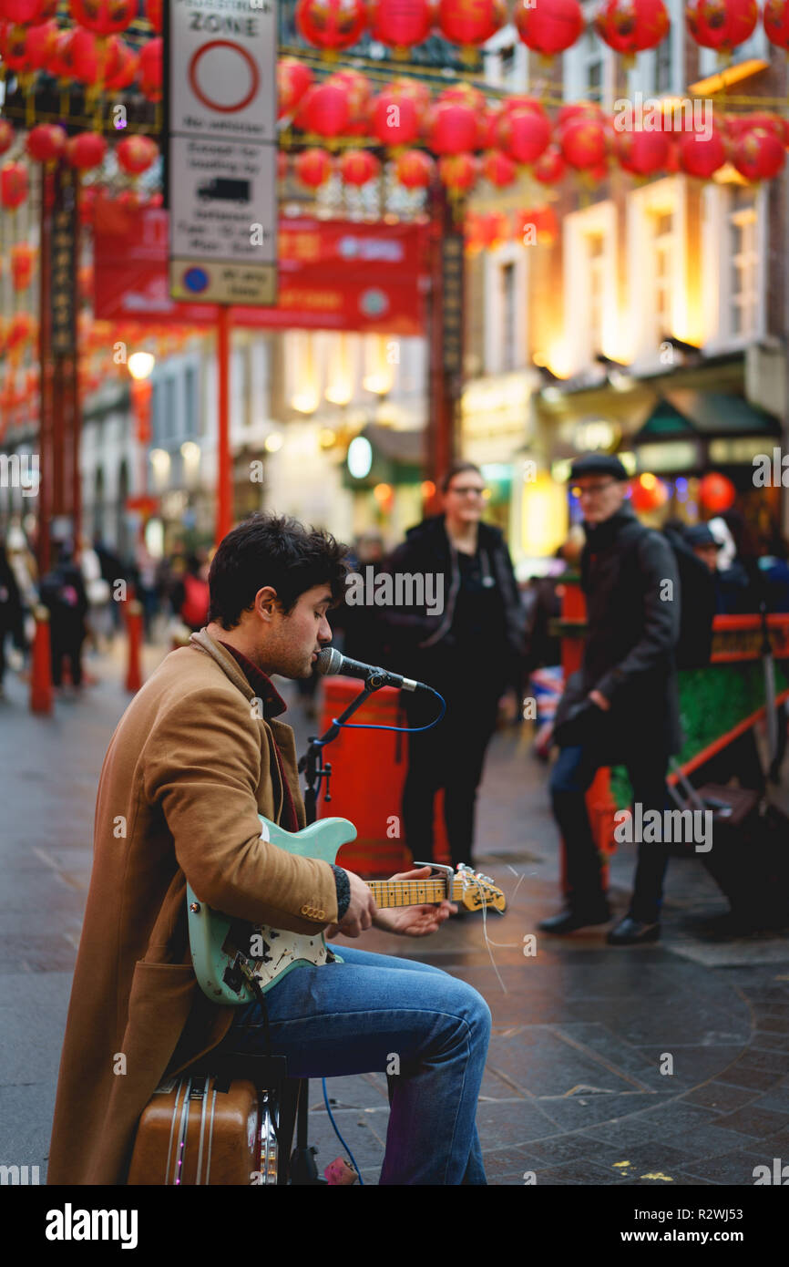 London, UK - February, 2019. Street musician playing a guitar during a ...
