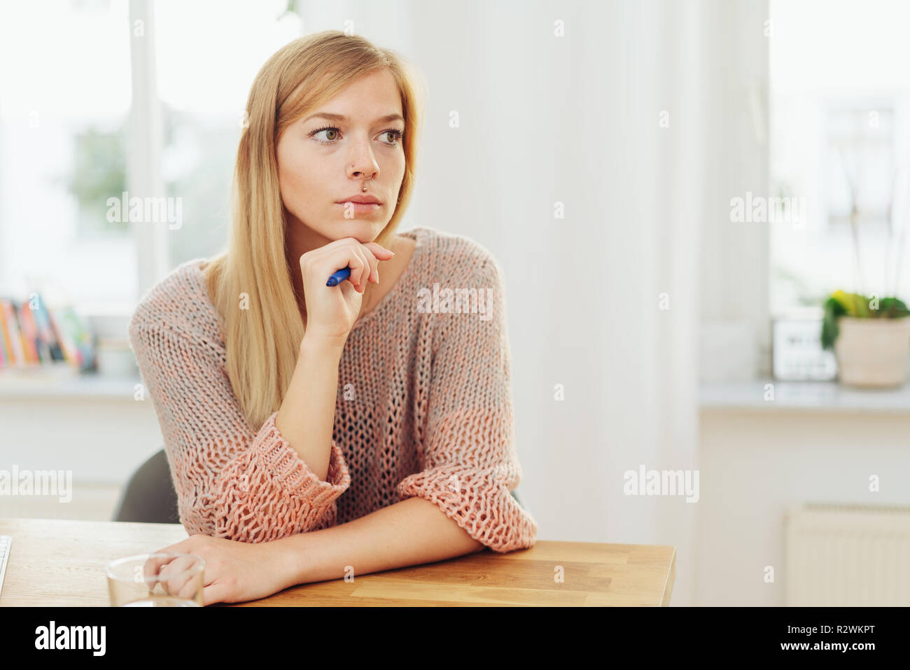 Female resting chin on hand hi-res stock photography and images - Alamy
