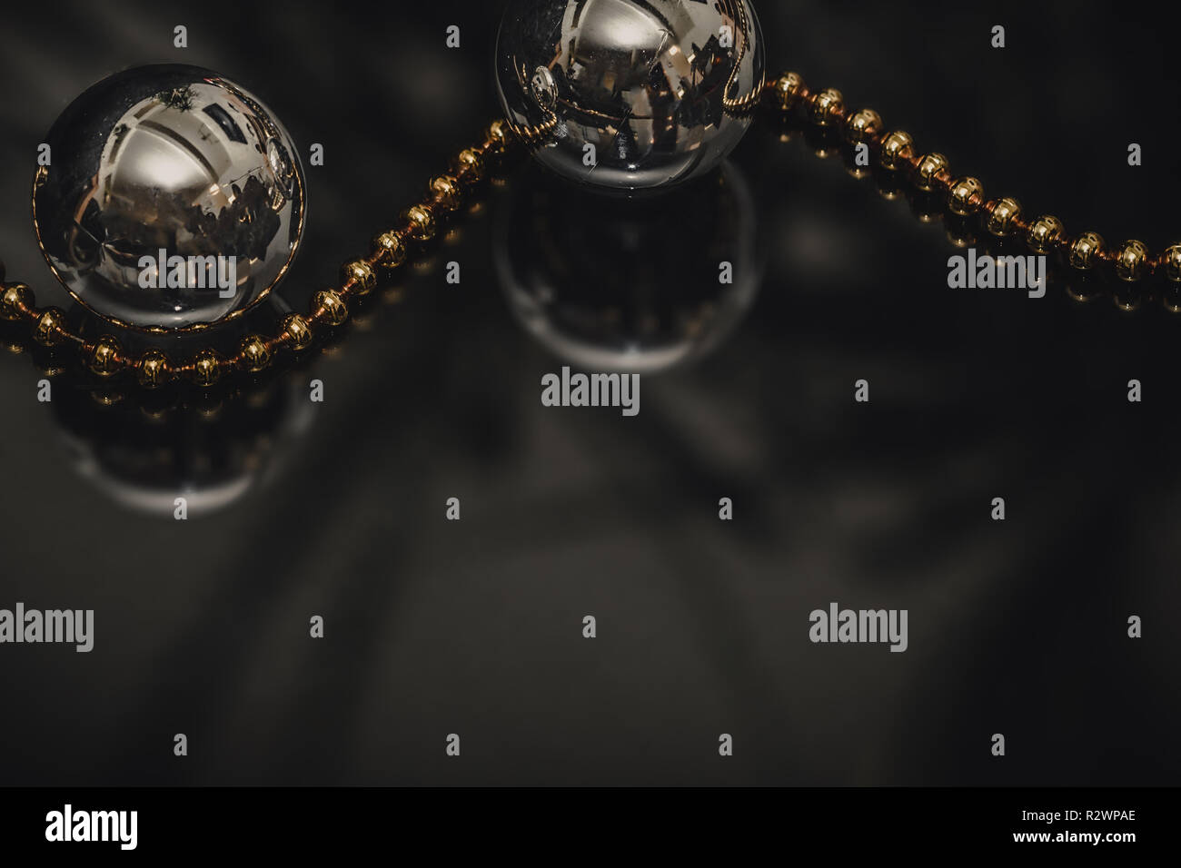 Christmas baubles and golden tree chain. Motive with two baubles and ...