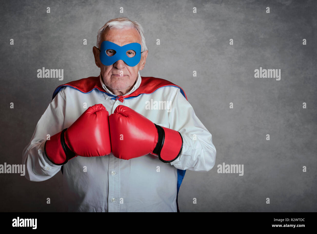 senior man with boxing gloves on gray background Stock Photo - Alamy