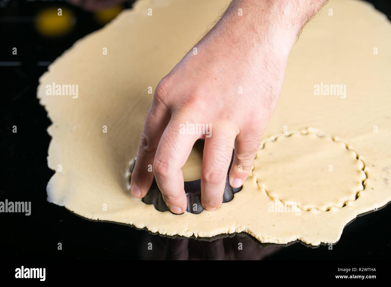 Chef prepairing tart base with cutting shape Stock Photo - Alamy