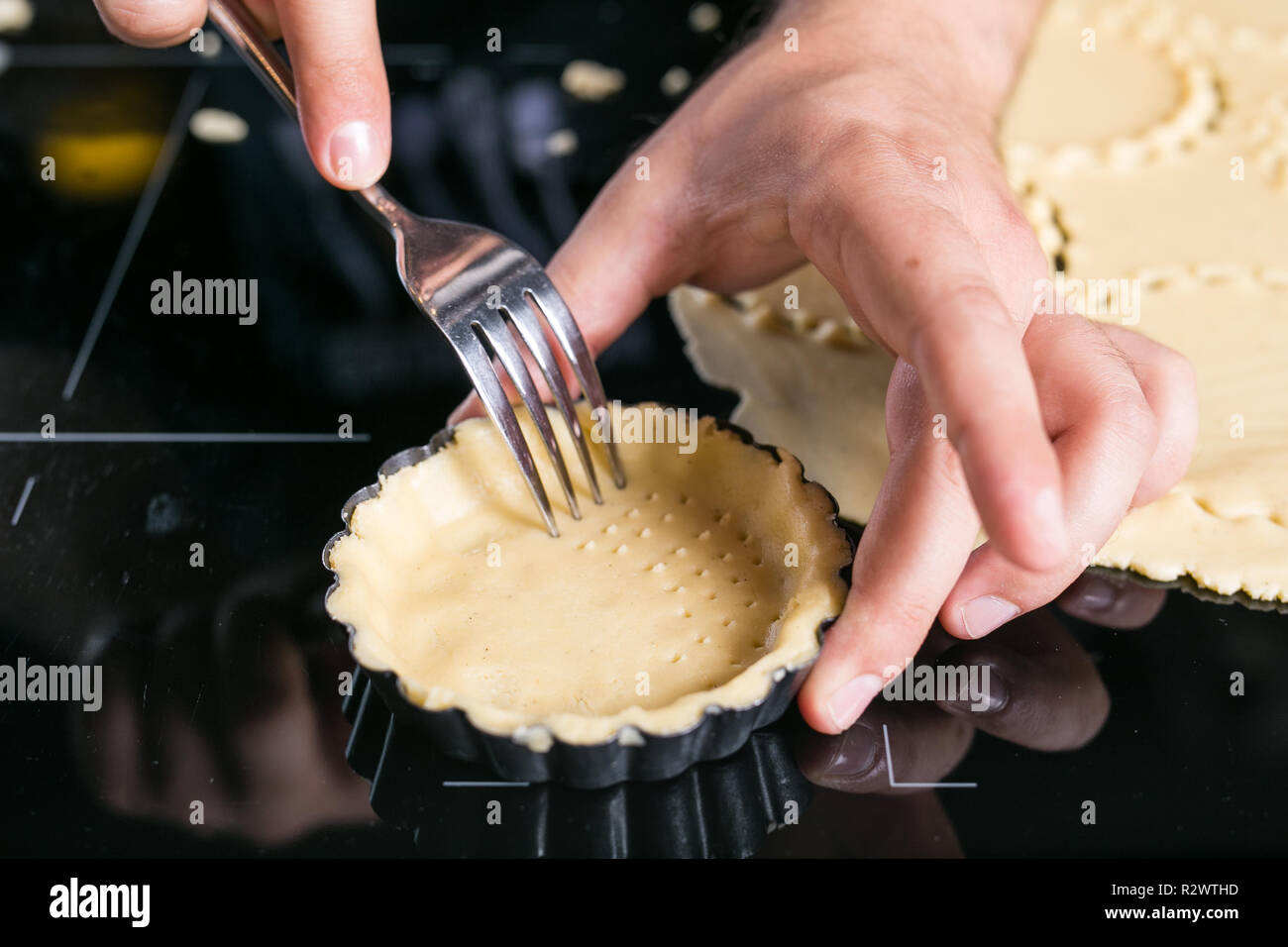 Chef prepairing tart base with cutting shape Stock Photo - Alamy