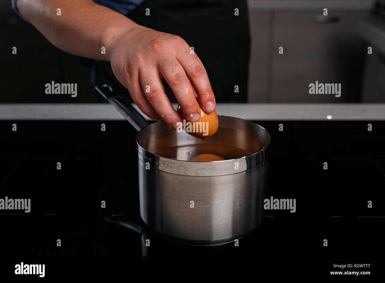 Chef removing an egg from water Stock Photo - Alamy