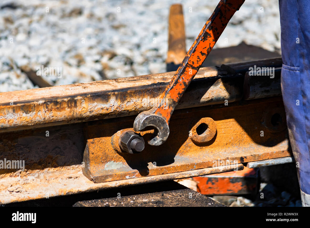 Worker tightens the skrew in railway or tram tracks Stock Photo - Alamy