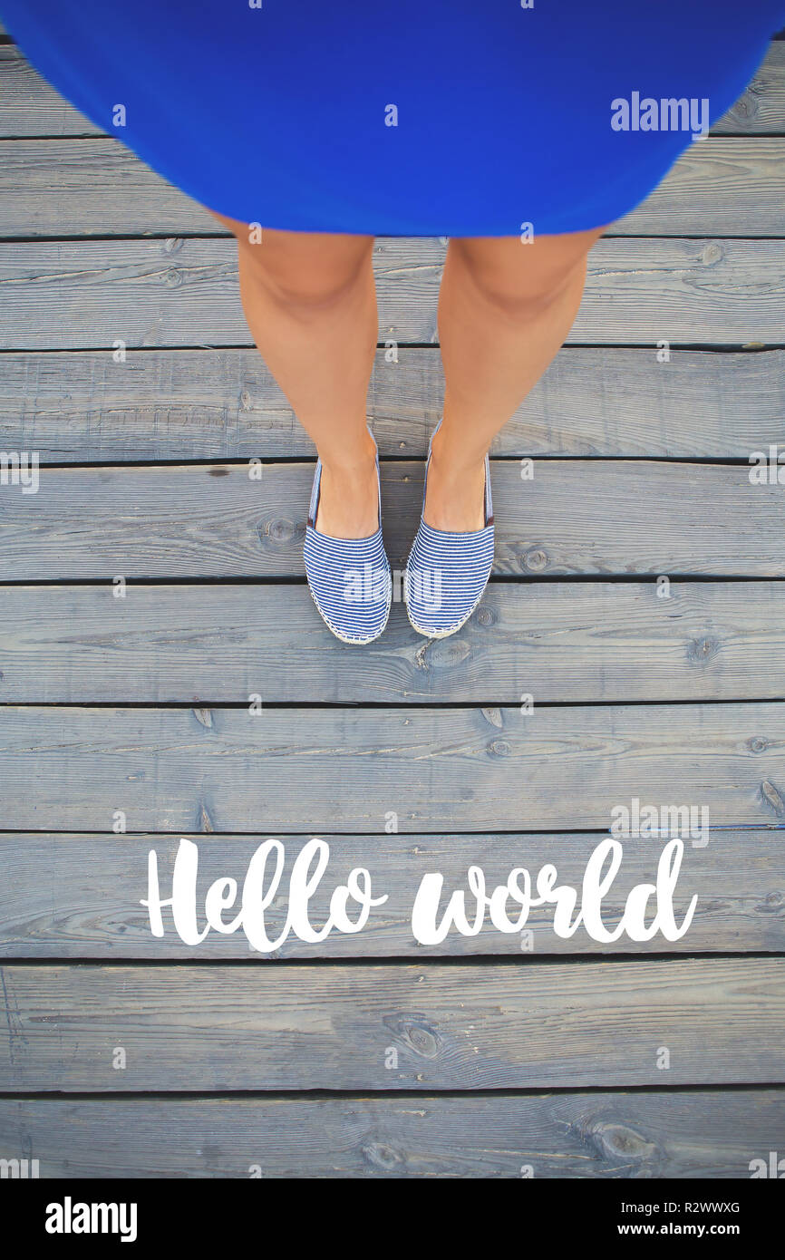 girl's legs stand in a blue dress on a wooden bridge-inscription hello ...
