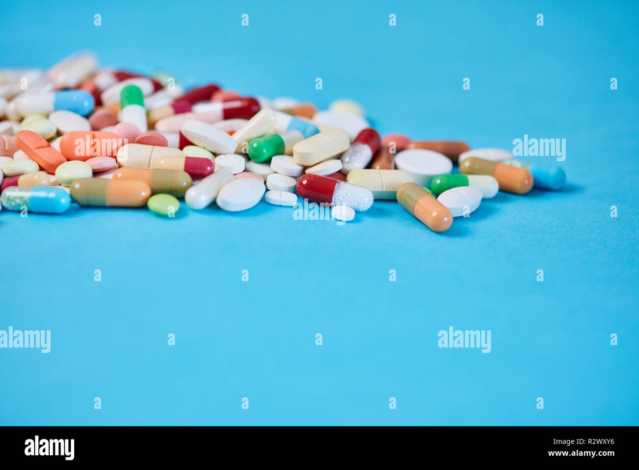 Colorful pharmaceutical remedy medicine background with many tablets ...
