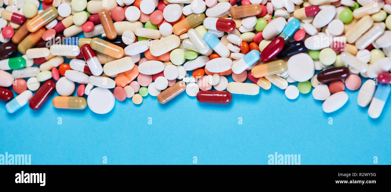 Medicine header background with many colorful medicines Stock Photo - Alamy