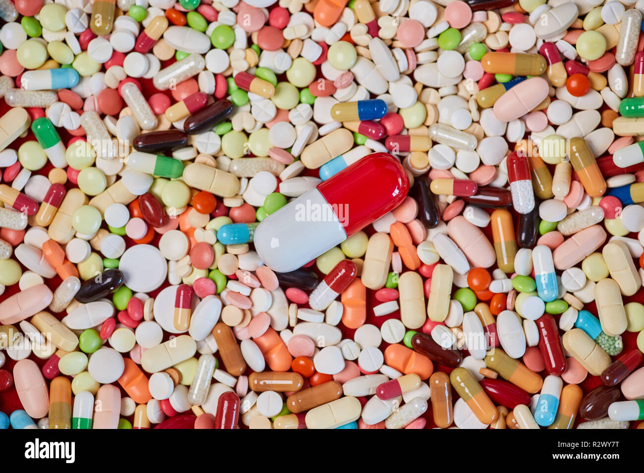 Big pill lies on many colorful medicines Stock Photo - Alamy