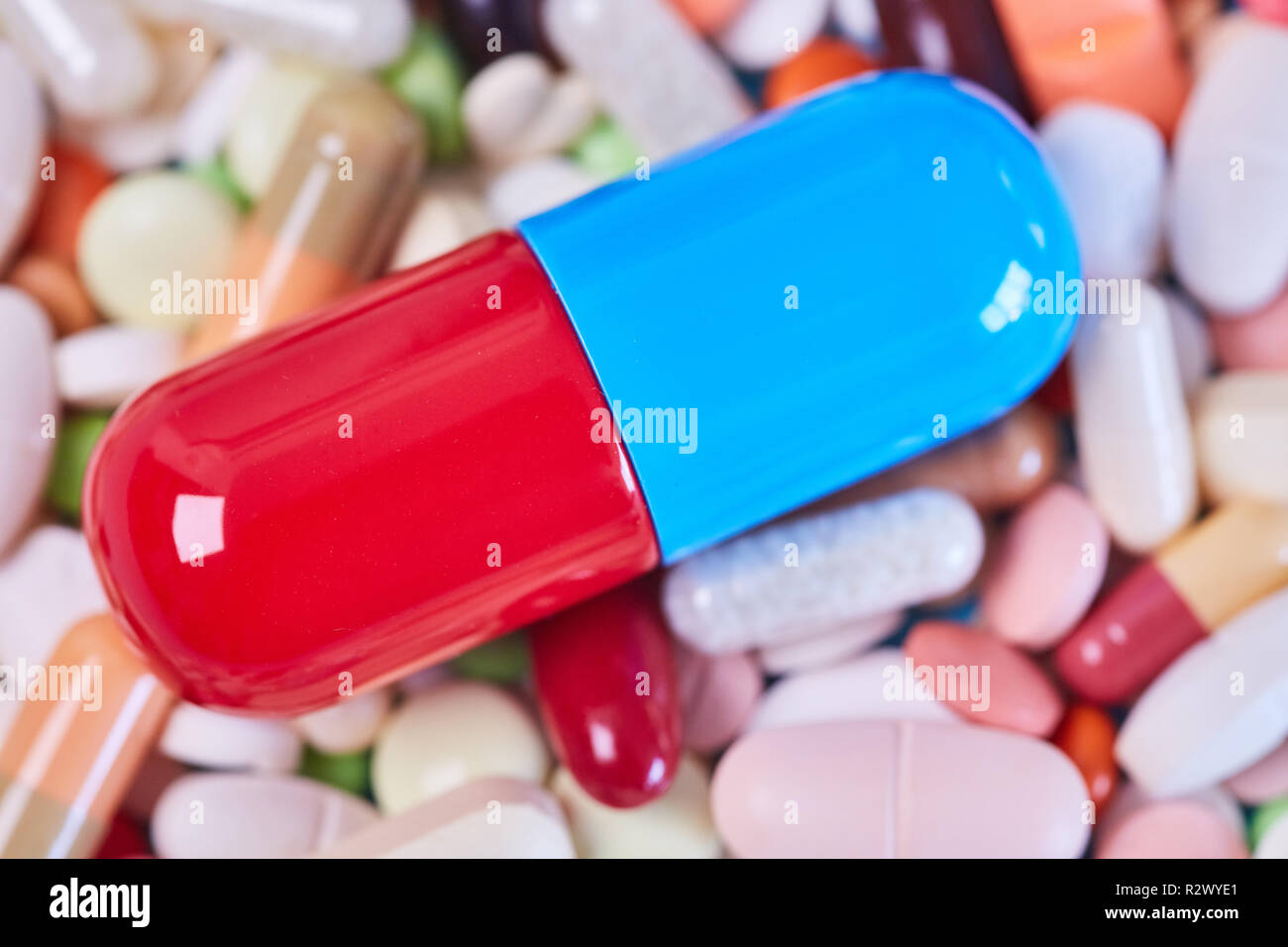 Big pill or capsule is on many colorful medications Stock Photo - Alamy