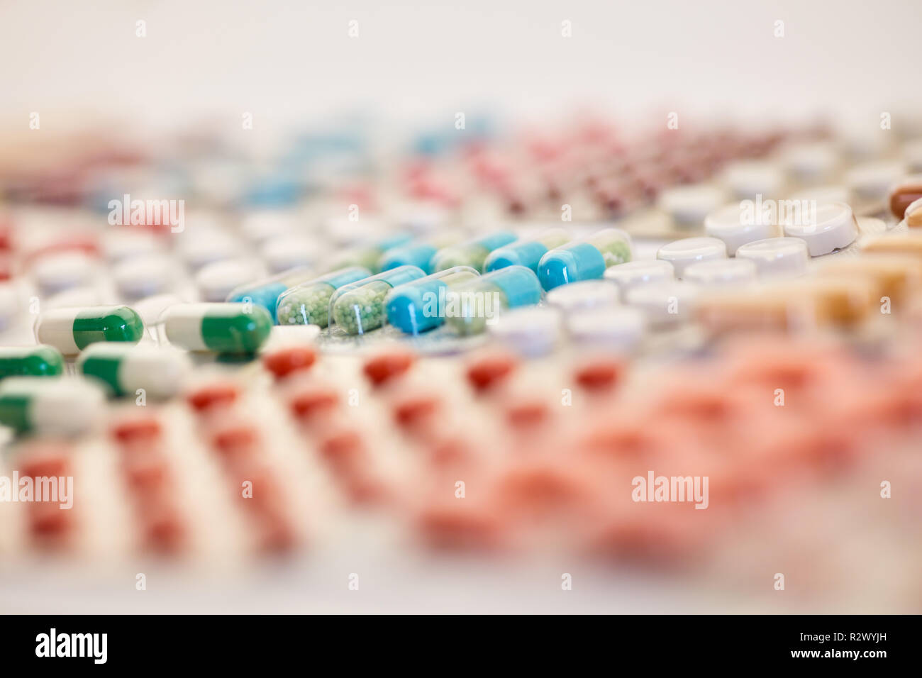 Many colorful medicines are sorted in blister packaging next to each ...