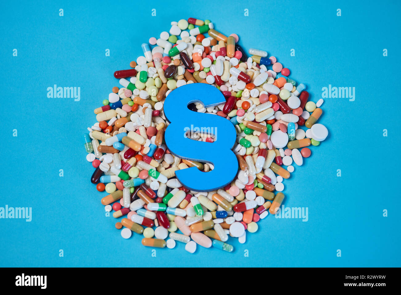 Medicine law with medicines and paragraph signs on a blue background ...