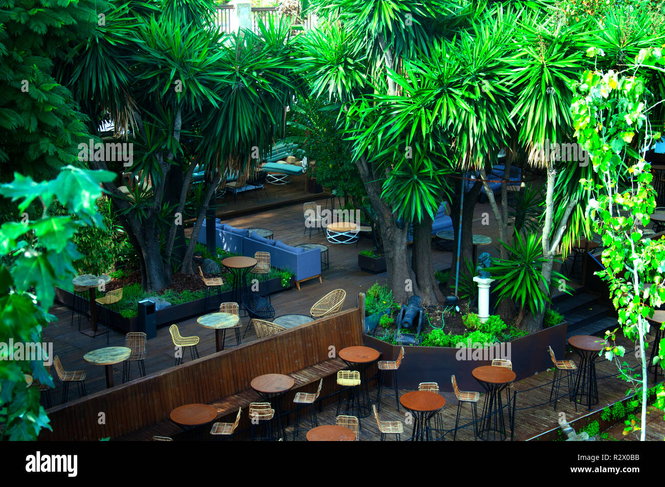 View of outdoor restaurant with green trees, summer Stock Photo - Alamy