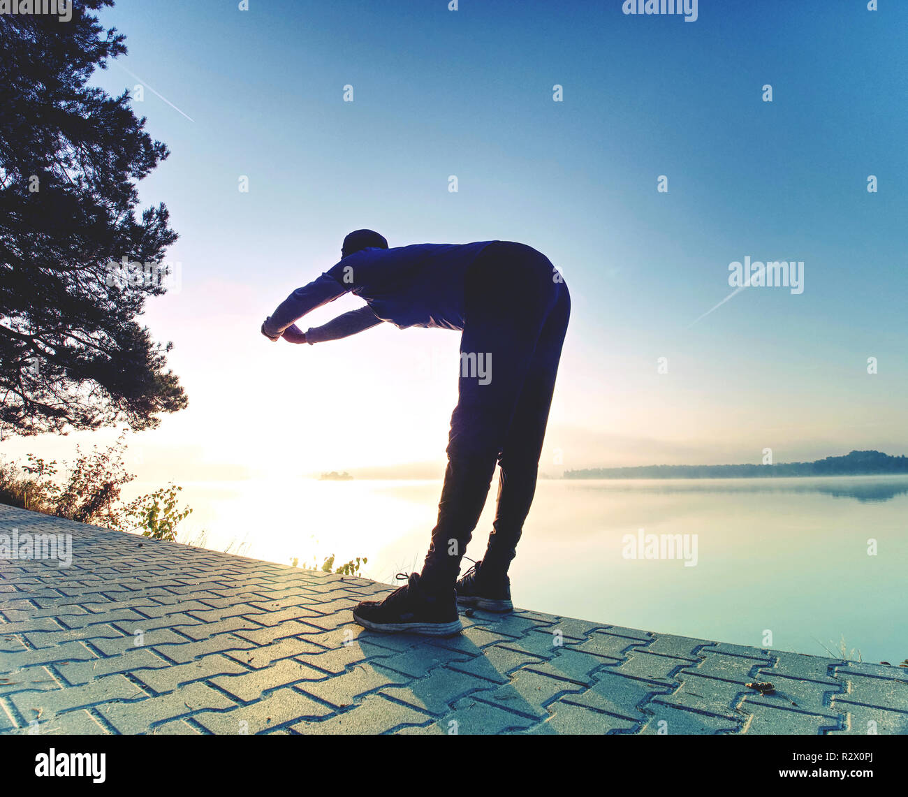 Mature man stretches muscles while resting after jogging. Happy sports ...