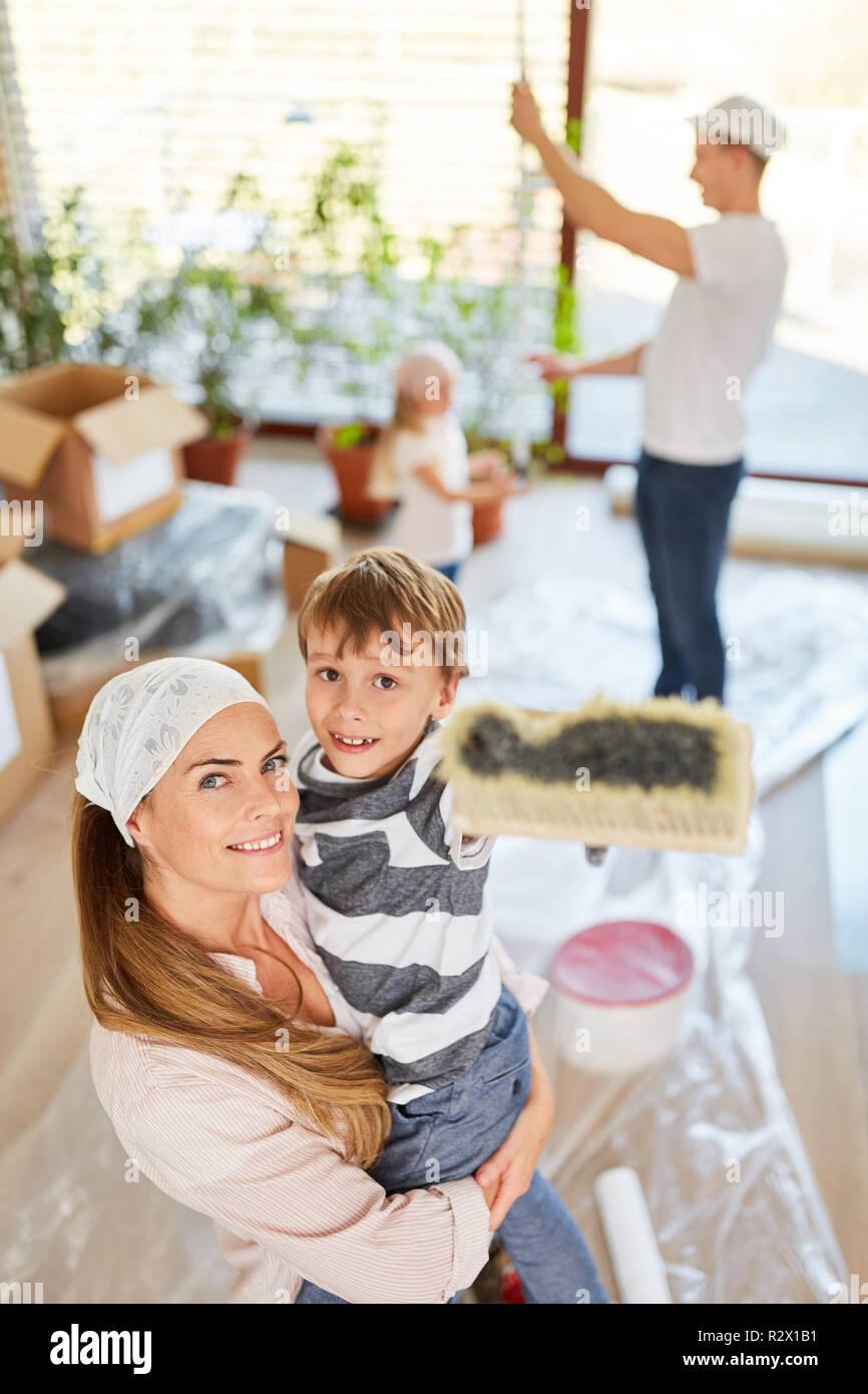 Happy children help family with renovation before moving into their own ...