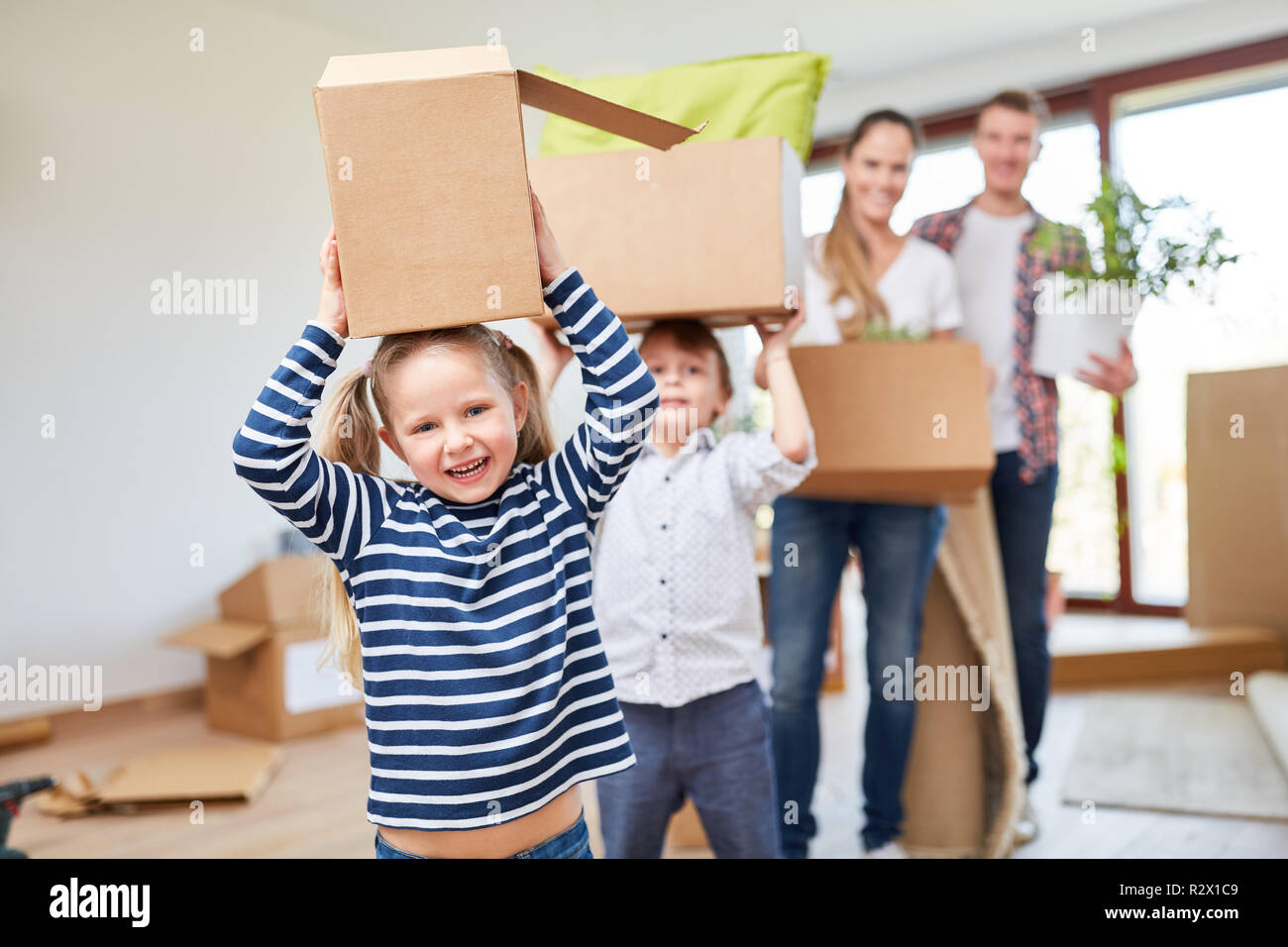 Children enjoy moving and help carry the moving boxes Stock Photo - Alamy
