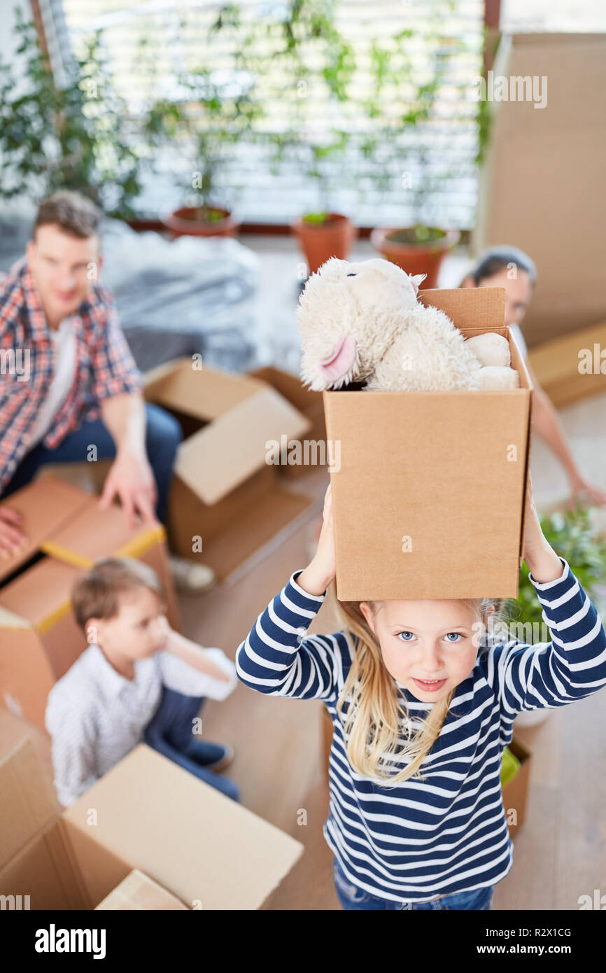 Little girl carries cardboard with her stuffed animal when moving to ...