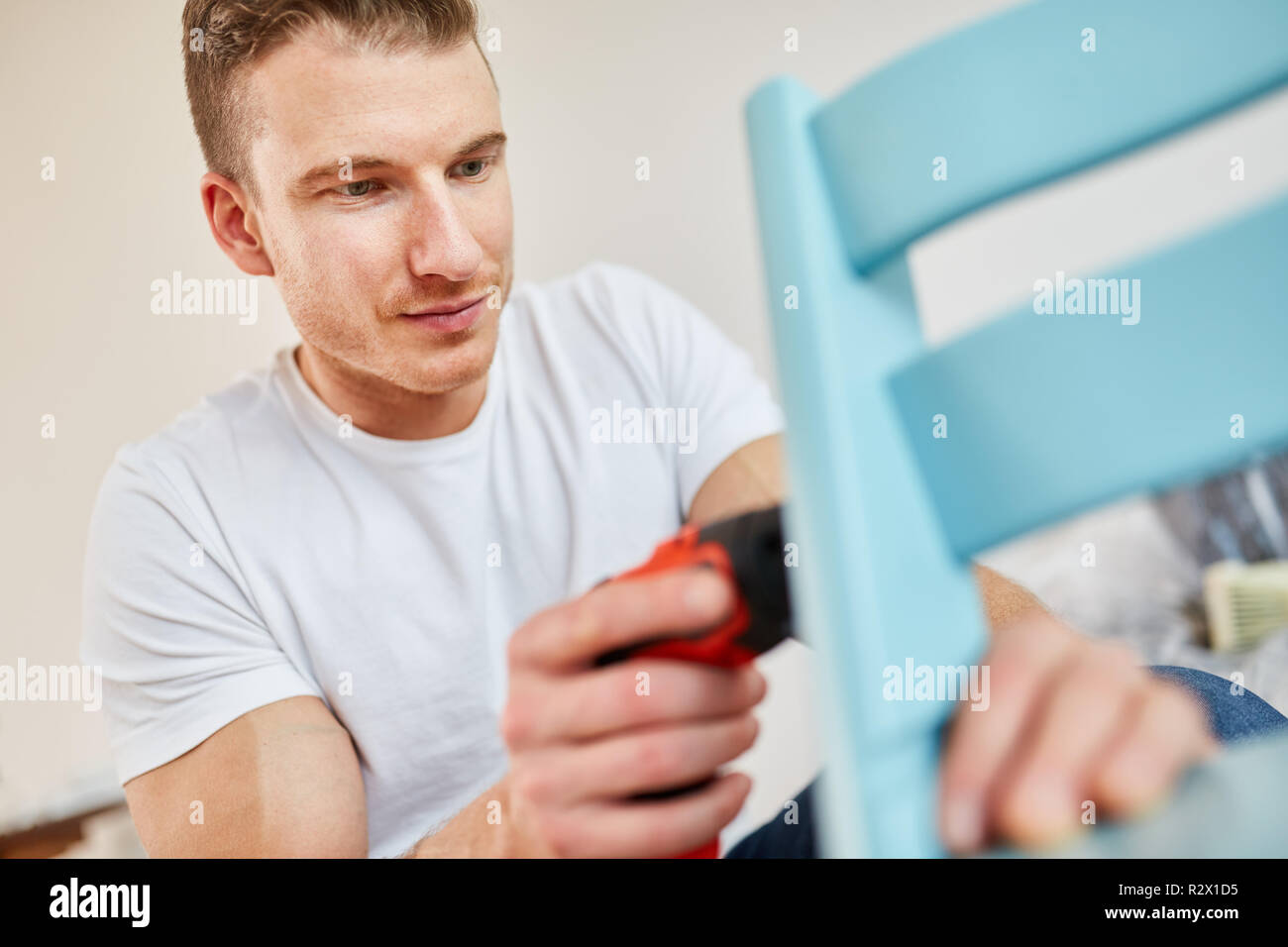 Man as a craftsman or handyman during the assembly of a chair Stock ...