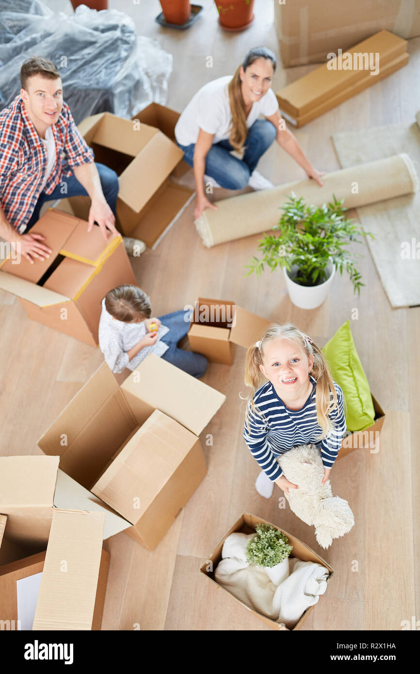 Family and children packing moving boxes in their new home Stock Photo ...