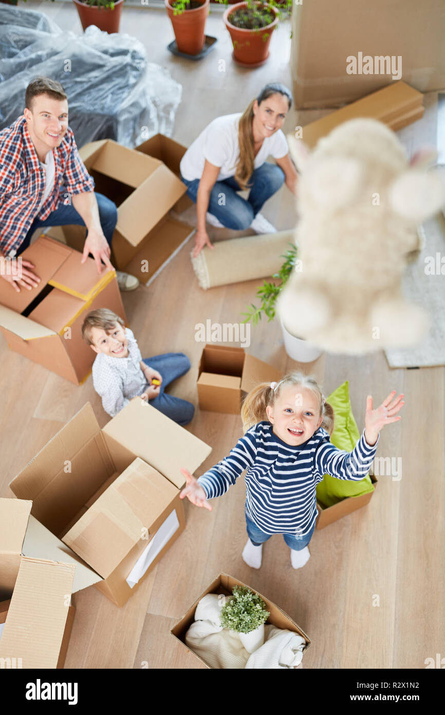 Children enjoy moving while packing and throw a cuddly toy Stock Photo ...