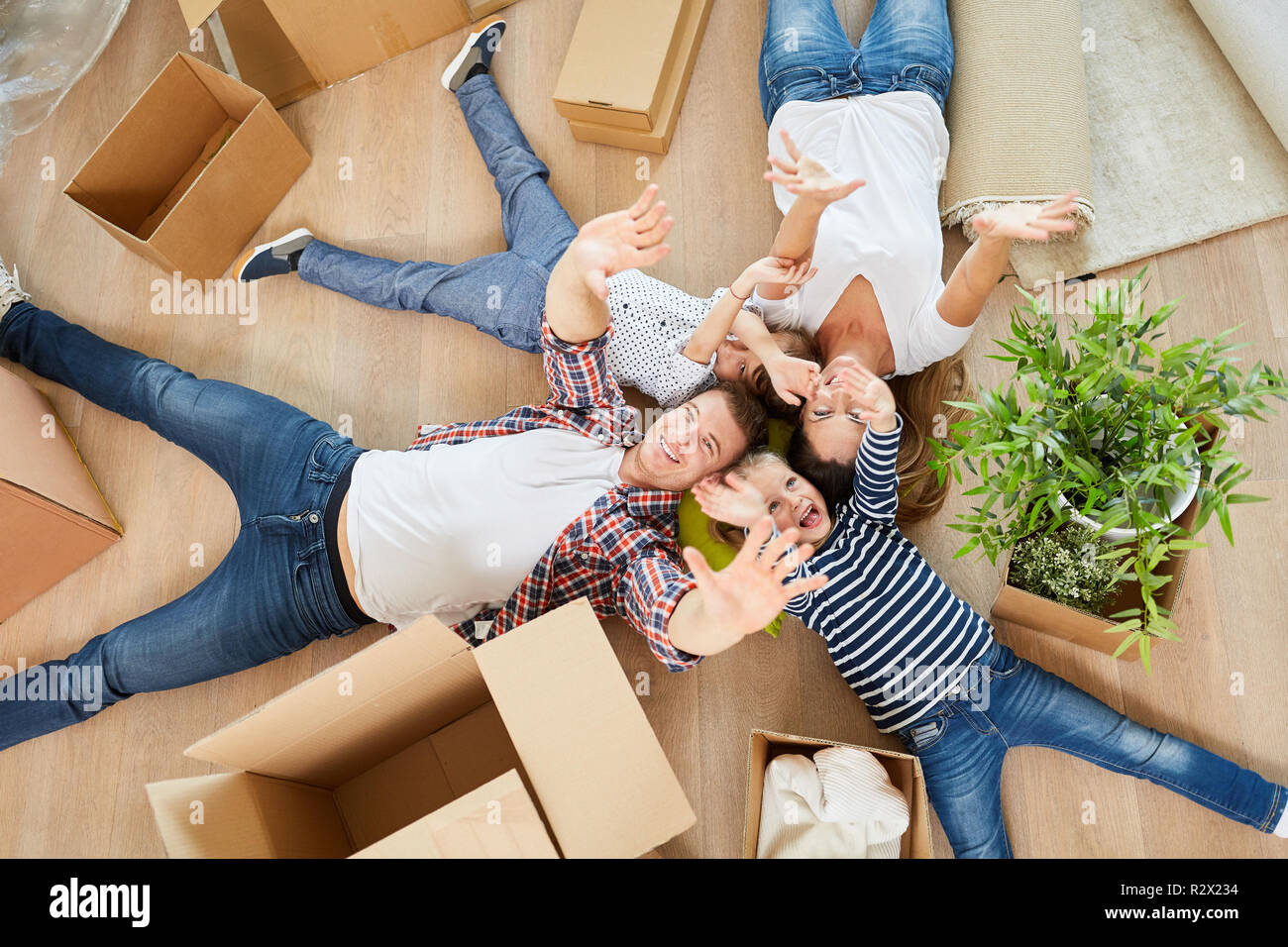 Happy family and children are happy about the move to their new home ...