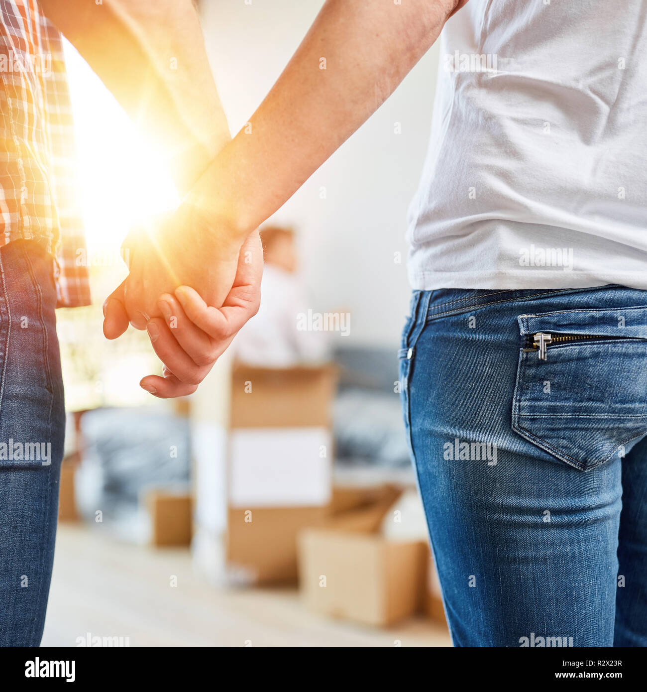 Happy couple while holding hands in new home Stock Photo - Alamy