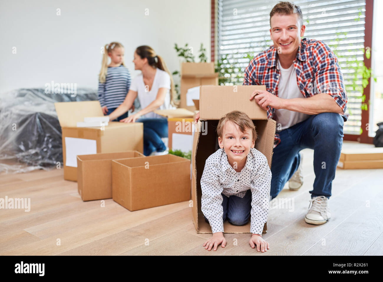 Father and son play with moving box when moving to a new house Stock ...