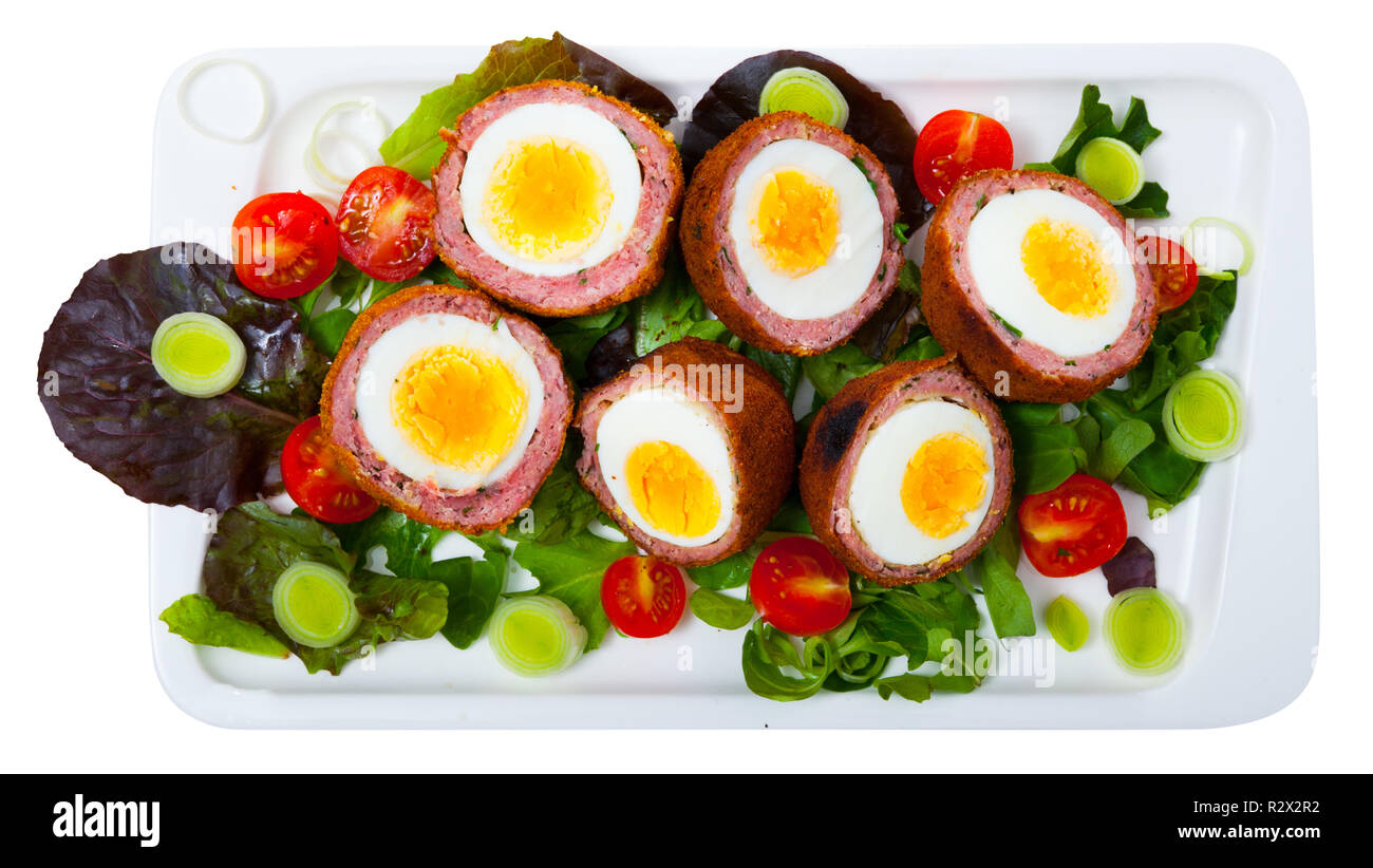 Top view of traditional Scottish dish - Scotch eggs served with garnish ...