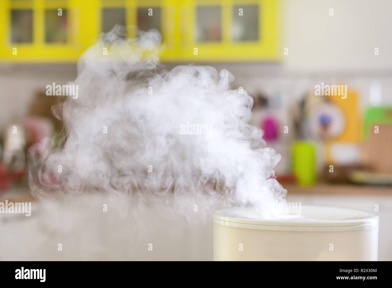 Humidifier in the kitchen and vapor from it Stock Photo - Alamy