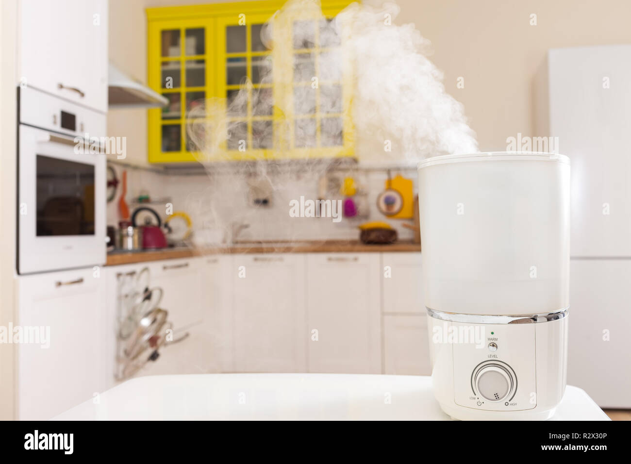 Humidifier in the kitchen and vapor from it Stock Photo - Alamy
