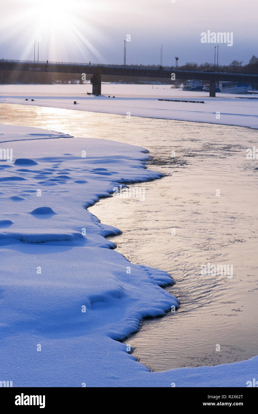 Bridge over freezing river Stock Photo - Alamy