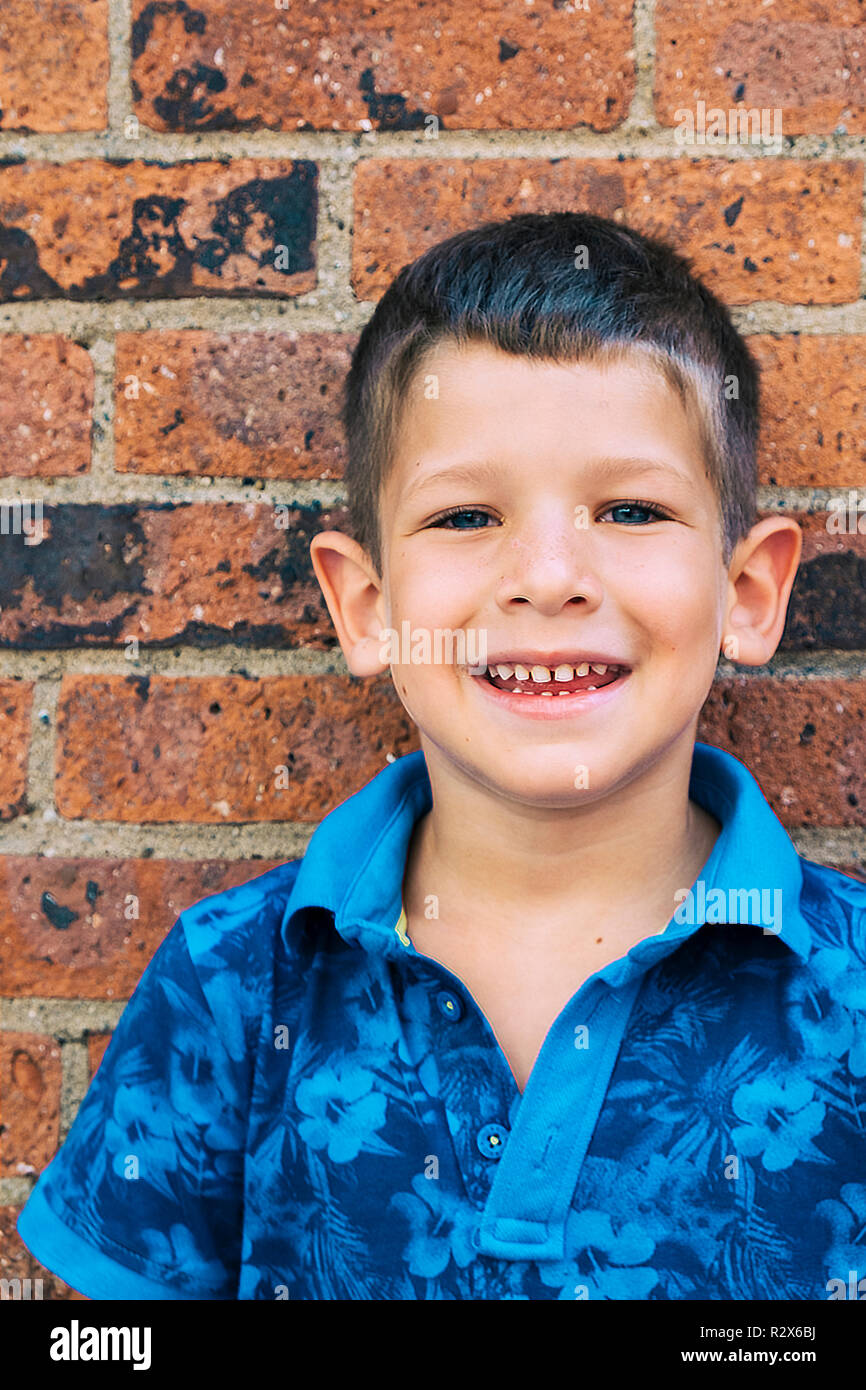 Portrait of kid on brown brick wall Stock Photo - Alamy