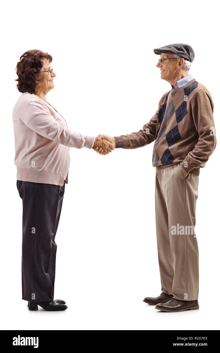 Full length profile shot of an elderly woman and an elderly man shaking ...