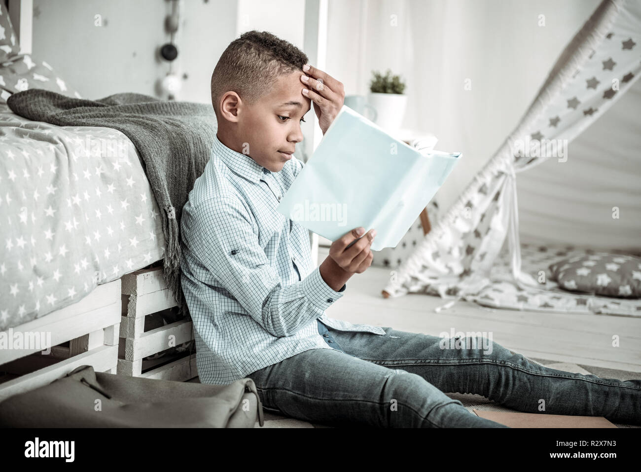 Smart nice boy taking notes with a pencil Stock Photo - Alamy