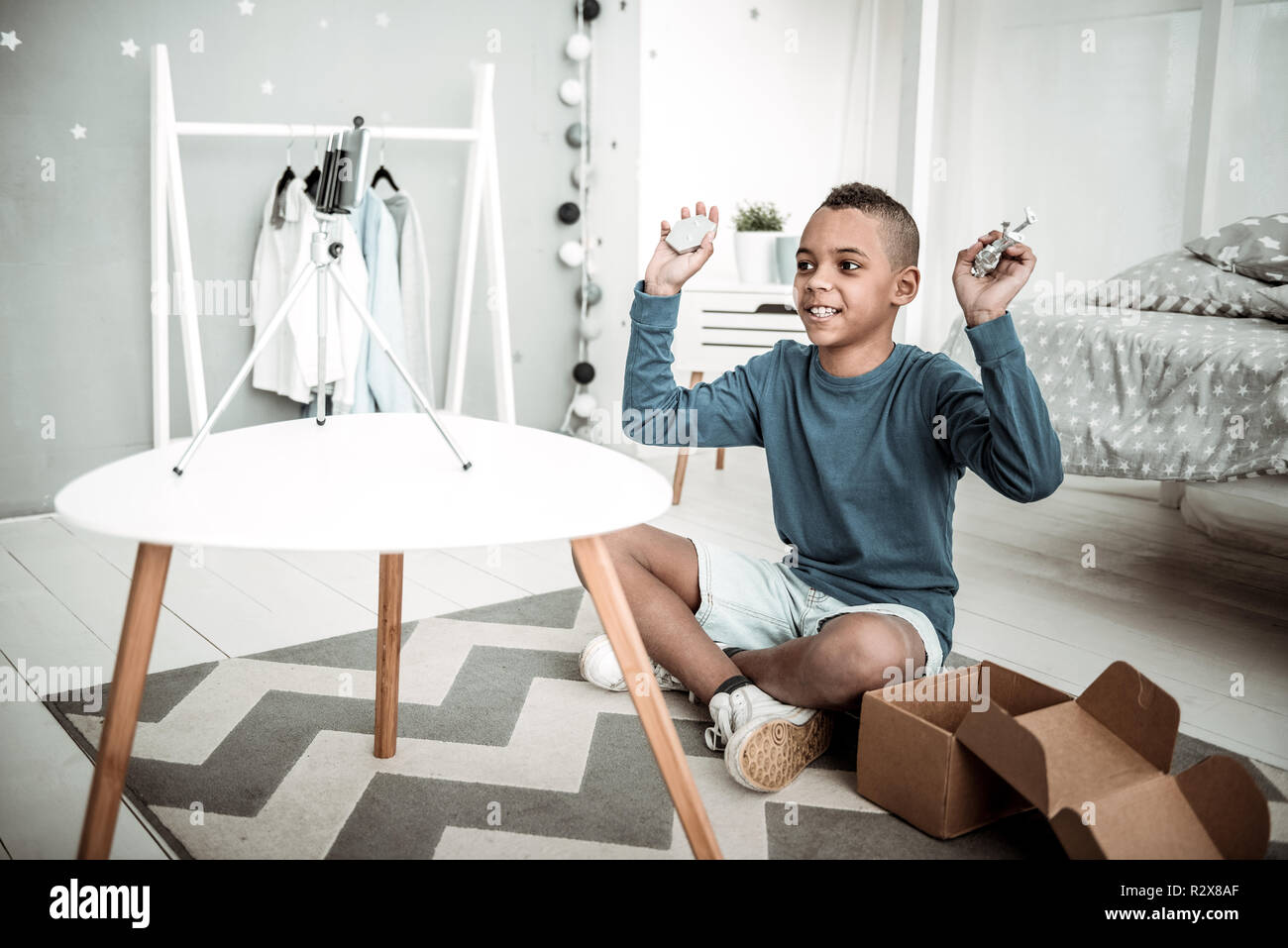 Happy nice boy showing his new toys Stock Photo - Alamy