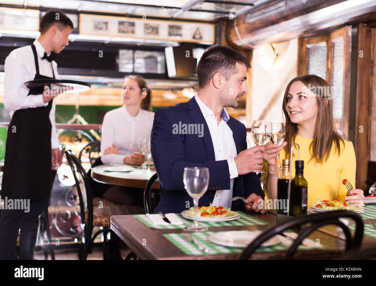 Portrait of couple who is dining and drinking wine in luxurious ...