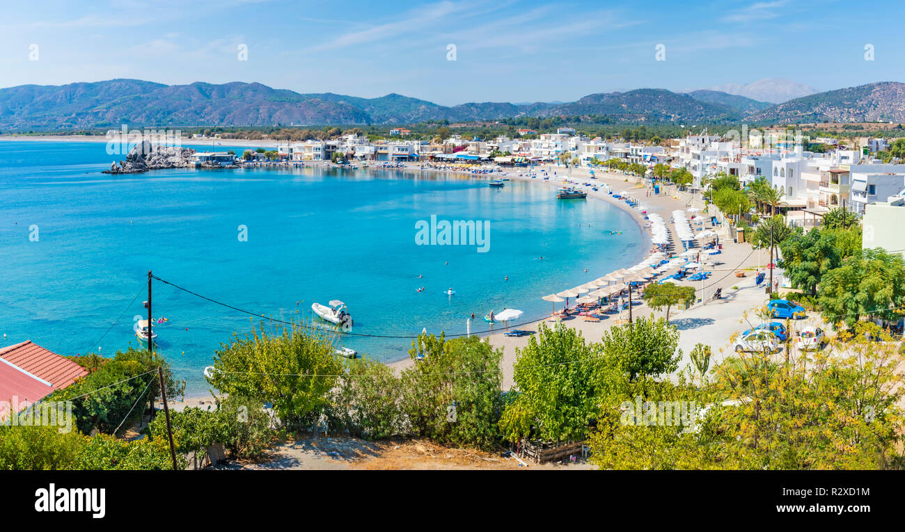 Haraki beach with apartment houses and holiday makers enjoying their ...