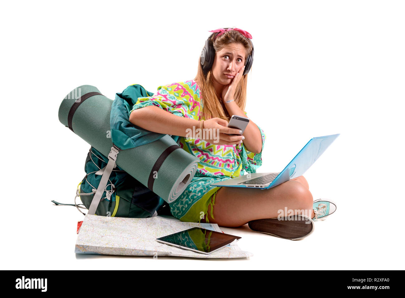 Lost and stressed girl with many devices looking for directions ...