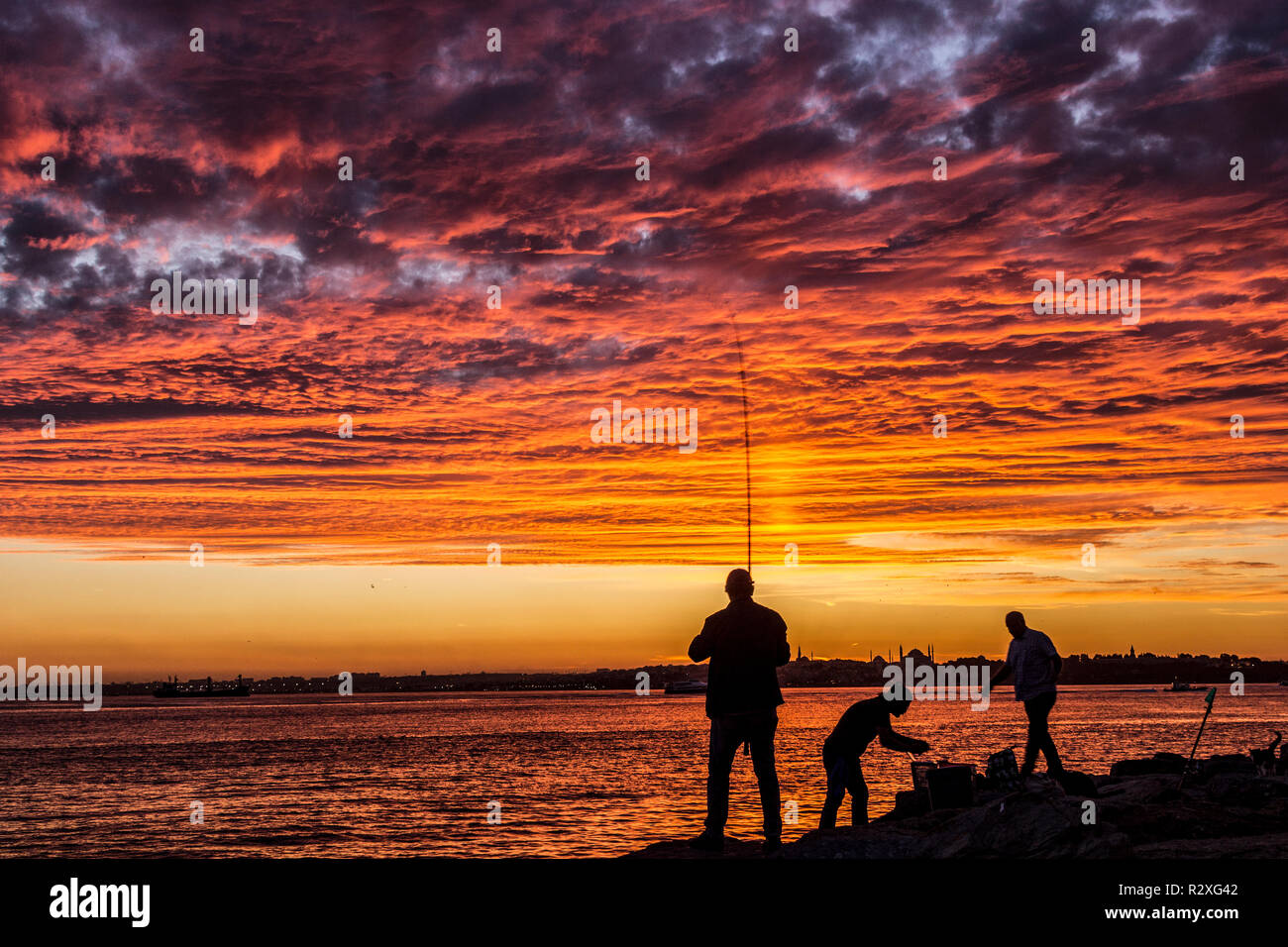 Sunset and Fishermen Stock Photo - Alamy