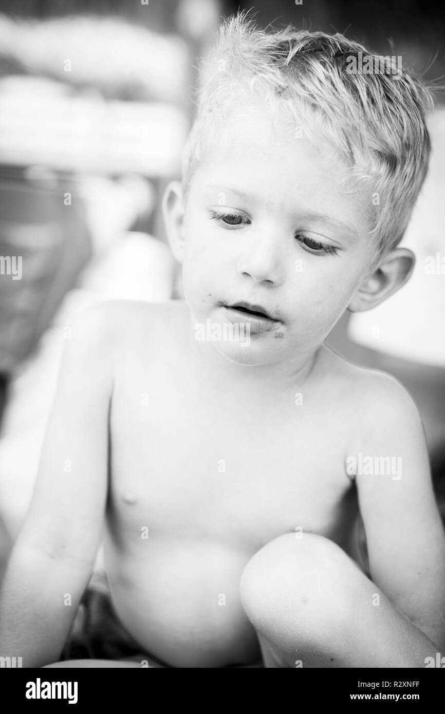 Portrait of caucasian white kid boy with chocolate on his face,vertical ...
