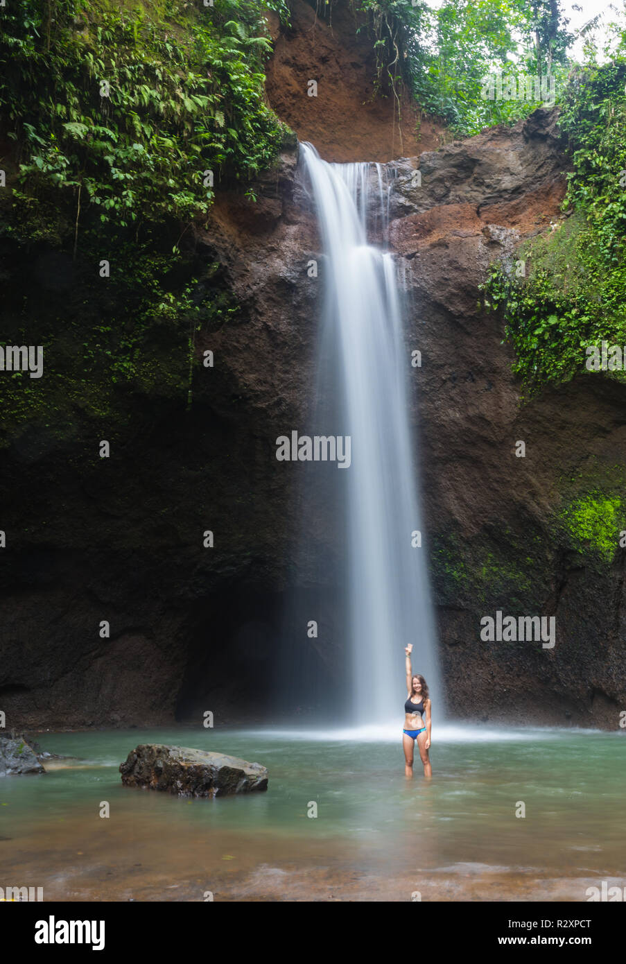 Girl In Front Of A Waterfall in Bali Stock Photo - Alamy