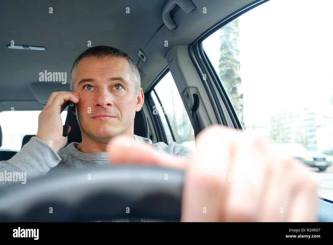 The man behind the wheel sitting in the car. Takes a phone call Stock ...