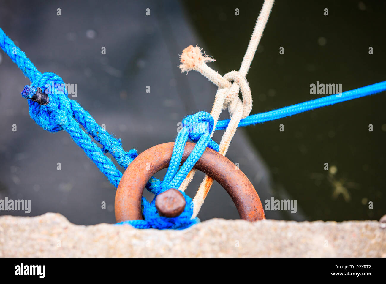 Dock ring trussed wrapped with mooring rope, docking line, hawser in ...