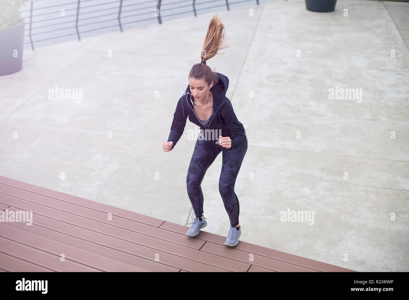 Fitness woman jumping outdoor in urban enviroment by day Stock Photo ...