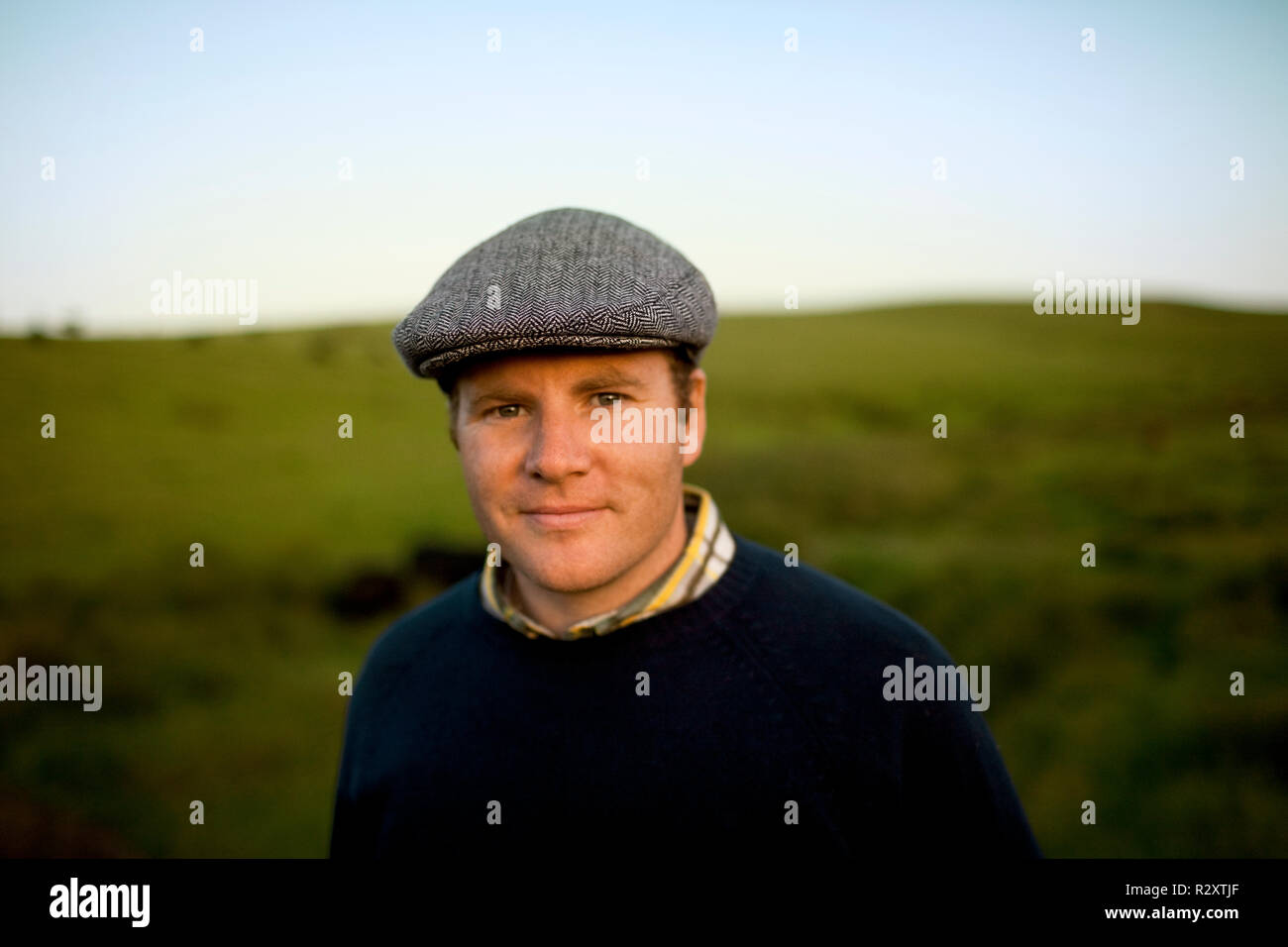 Portrait of a smiling mid-adult farmer wearing a tweed cap Stock Photo ...