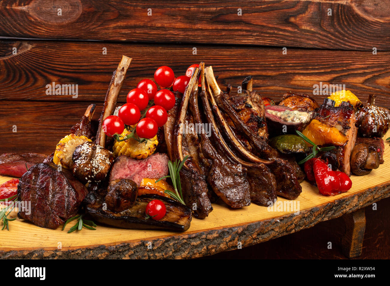 Mixed Grilled meat and vegetables on wooden background. restaurant feed ...