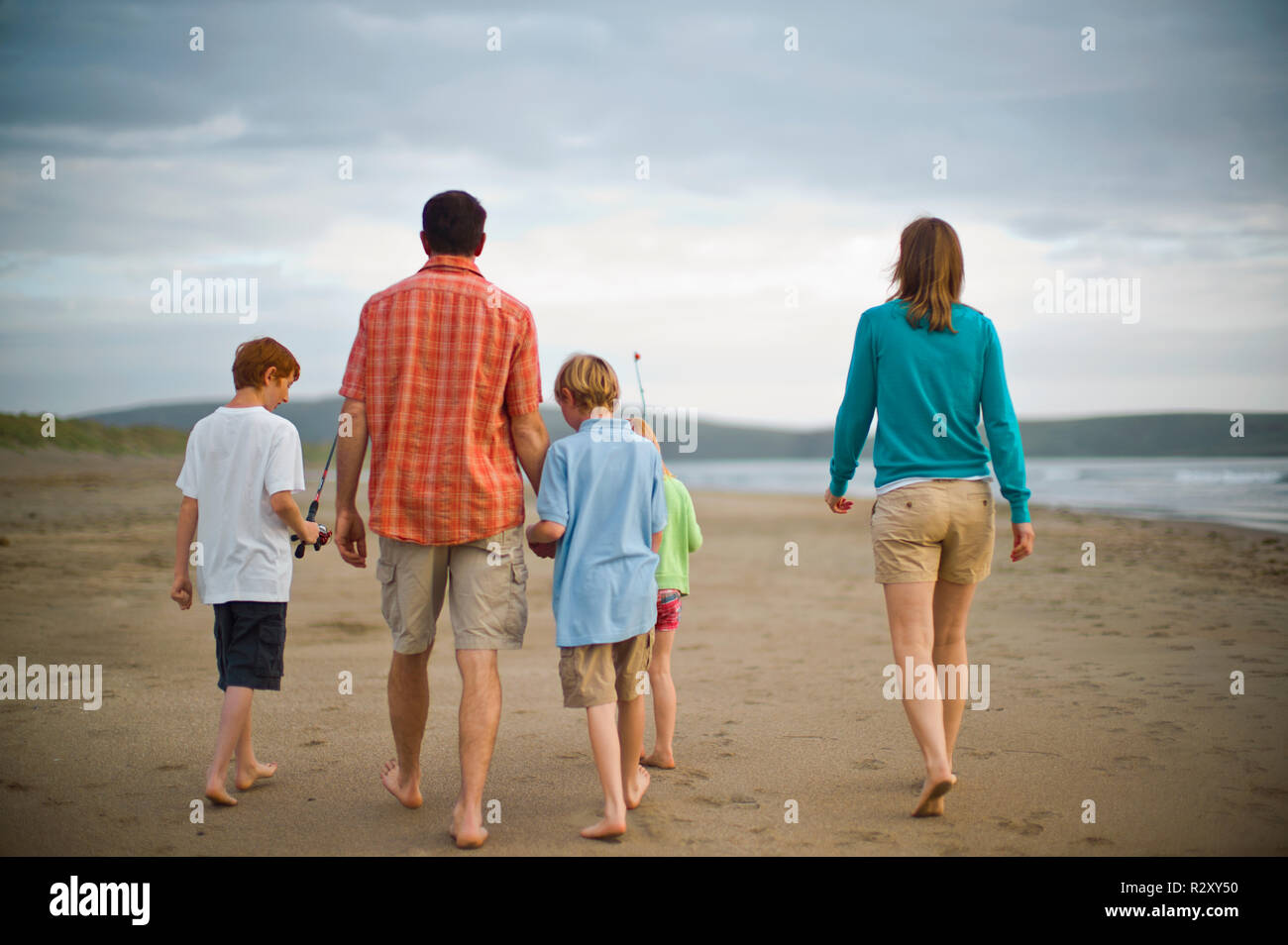 Three siblings holding hands walk hi-res stock photography and images ...