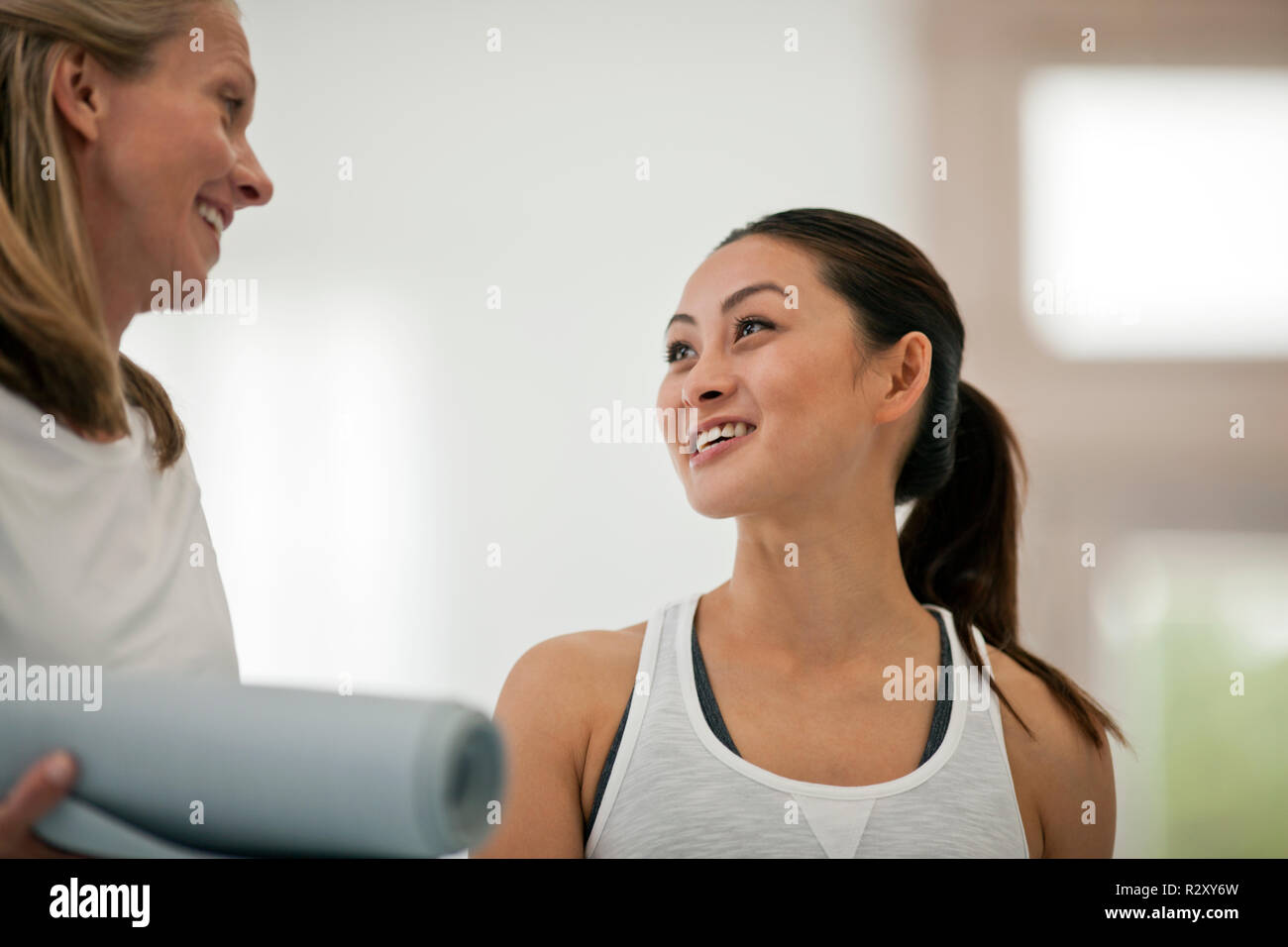 Happy friends smiling at one another Stock Photo - Alamy