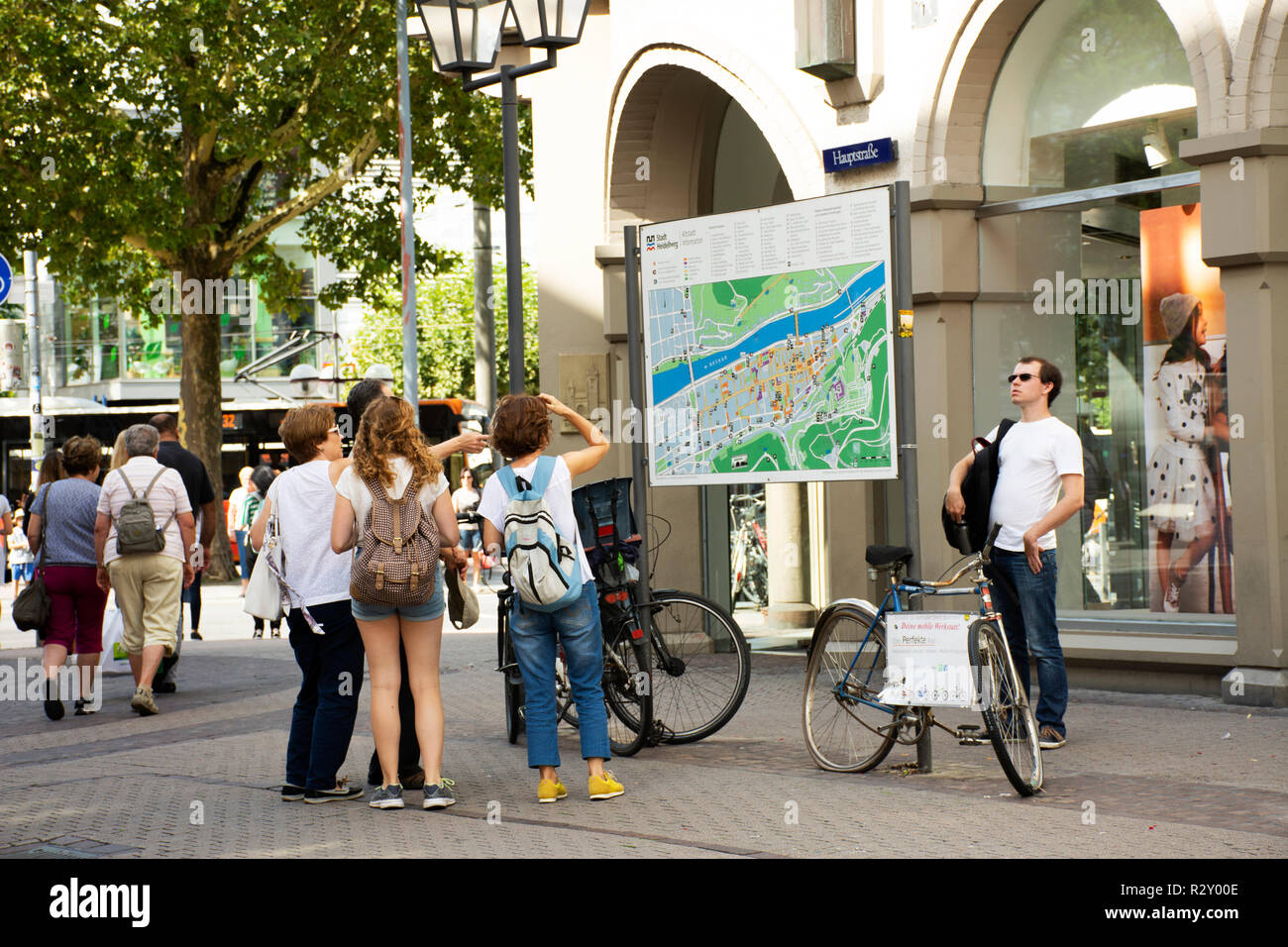 German people and foreigner travelers looking map of landmarks of ...