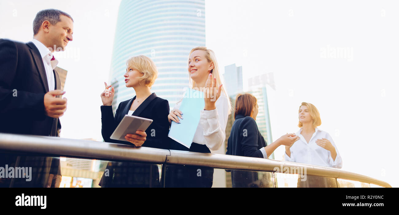 Businesswomen speaking with male boss outside Stock Photo - Alamy